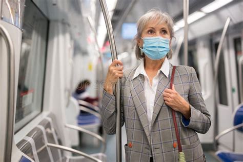 Mature Woman In Mask Standing In Subway Train Stock Image Image Of