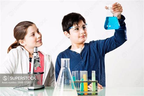 Babe And Girl During A Chemistry Class SuperStock