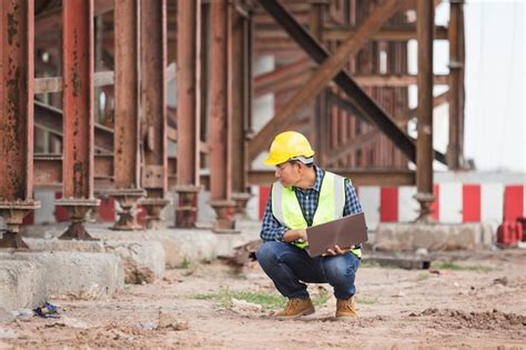 Premium Photo Engineer Checking Project At Site Man In Hardhat With Laptop At The