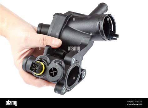 The Body Of The Thermostat And The Engine Temperature Sensor Of The Car In Hands Is Isolated On