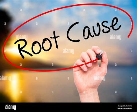 Man Hand Writing Root Cause With Black Marker On Visual Screen Isolated On Nature Business
