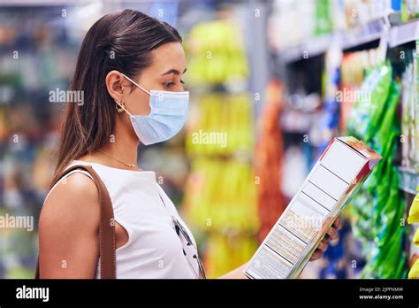 Woman Reading Food Box Information Or List At The Grocery Store Shop