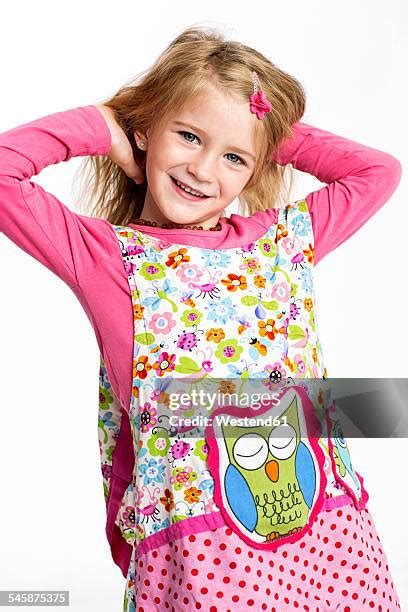 Portrait Of Perky Blond Girl With Hands In Her Hair Wearing Colourful