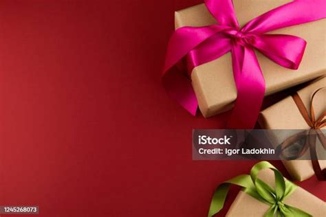 공예 용지에 세 개의 선물 상자와 복사 공간이있는 빨간색 배경 클로즈업에 컬러 리본으로 묶여 있습니다 0명에 대한 스톡 사진 및 기타 이미지 Istock