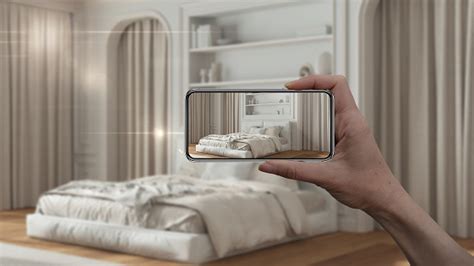 핸드 홀딩 스마트 폰 Ar 응용 프로그램 실제 가정에서 가구 및 인테리어 디자인 제품 시뮬레이션 건축가 디자이너 개념 흐림 배경 더블 침대가있는 고전적인 침실 Brand