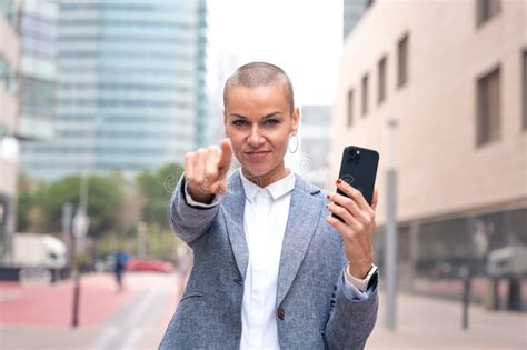 Confident And Smiling Business Woman Pointing Forward Looking At Camera