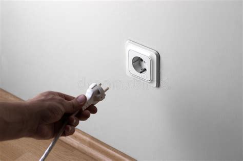 Man Hand Plugging Electric Plug A In A Socket On The Wall Stock Photo Image Of Living Life