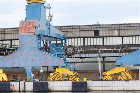 Industrial Crane And Dock Scene Showcasing Machinery And Structures Used In Shipping And Harbor