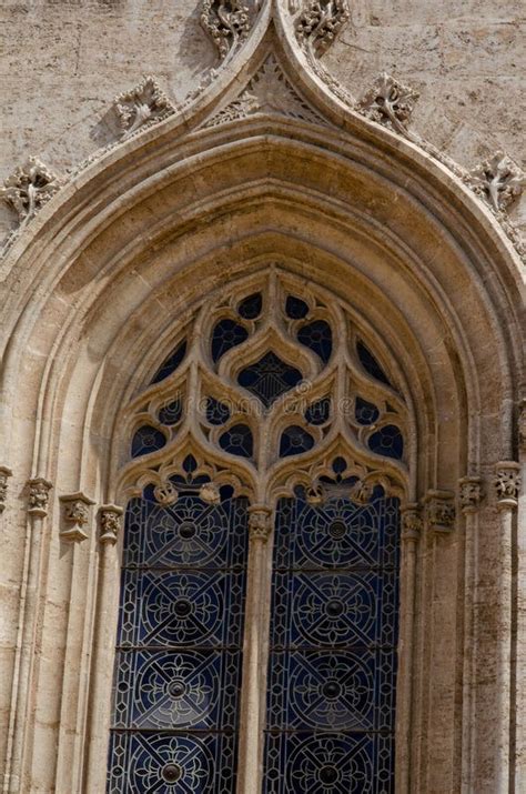 Gothic Church Window With Ornate Stone Arch And Stained Glass Detail