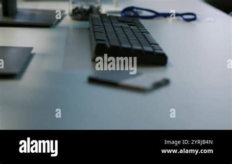 Close Up Of Computer Peripherals On Server Room Desk Used By Employees Working To Ensure Minimal