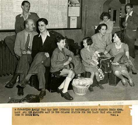 Nine Italian Refugees Seated In The Train Station Chiasso Switzerland