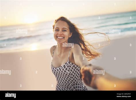 Paradise Is Never Too Far Away A Young Woman Pulling Someones Hand At