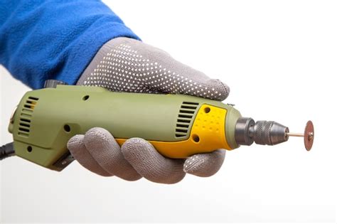 Premium Photo Engraving Tool For Cutting And Processing Metal And Other Objects In Hand On A