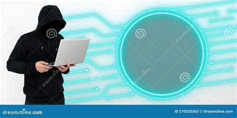 Male Programmer In Black Hoodie Stands And Holds Laptop Hacker With Hood On His Head Typing