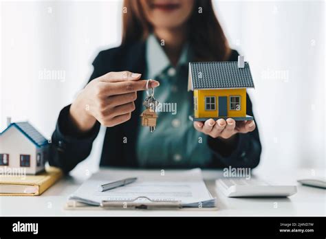 Asian Real Estate Agent Holding House Key To His Client After Signing Contractconcept For Real