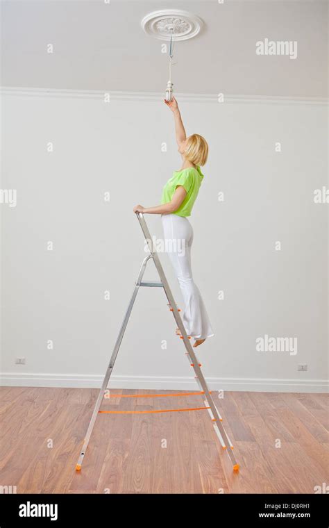 Woman Changing Light Bulb Hi Res Stock Photography And Images Alamy