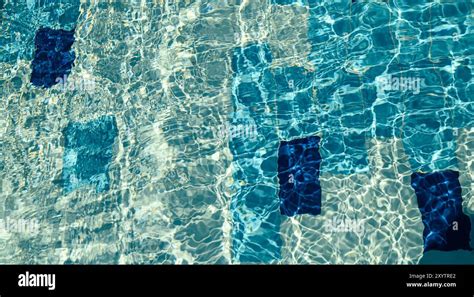 Swimming Pool Surface With Light Reflection And Water Ripple Patterns