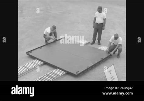 A Jeep Goes Through All Of The Rigging Stations Along A Rigging Assembly Line In The 1960s Stock