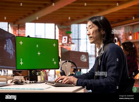 Senior Programmer Using Chroma Key Computer To Oversee Artificial
