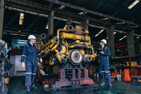 The Technician Repairing And Inspecting The Big Diesel Engine In The