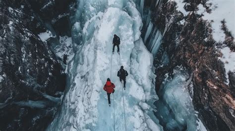 Climbers Ascending A Frozen Waterfall Premium Ai Generated Image
