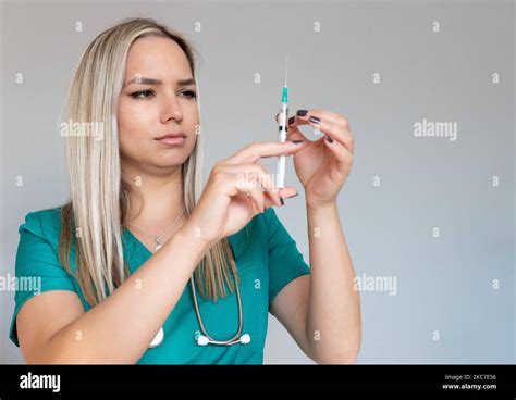 Female Doctor Or Nurse Holding Syringe With Injection And Medicine
