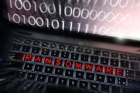 Ransomware Text On Illuminated Keyboard Of A Modern Laptop With Sequences Of 0s And 1s Displayed