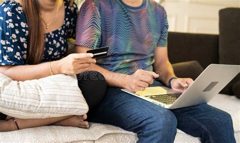 Close Up Shot Of Couple Making Online Payment For Shopping Using Credit Card On Laptop At Home