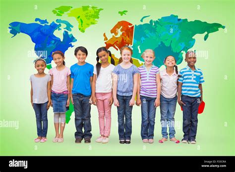 Composite Image Of Cute Pupils Smiling At Camera In Classroom Stock Photo Alamy