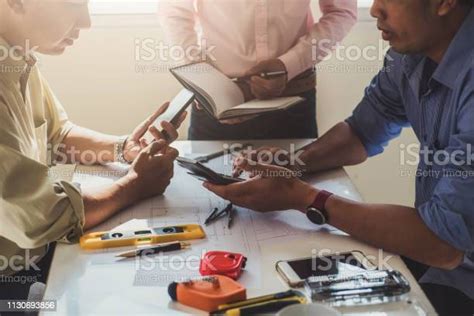 사무실의 회의 건물 계획 설계 프로젝트 중에 전화를 통해 건축가 또는 엔지니어가 메시지를 읽습니다 건설 엔지니어링 도구 및 구조 개념 개념에 대한 스톡 사진 및 기타 이미지