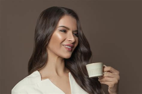 Premium Photo Pretty Woman Enjoying Espresso Coffee On Brown Background