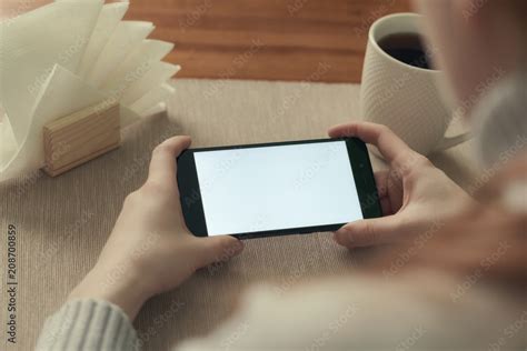 Girl Watching Video Or Play Game On Mobile Phone In Horizontal Position Isolated Screen For App