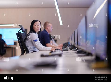 Female Security Operator Working In A Data System Control Room Offices Technical Operator