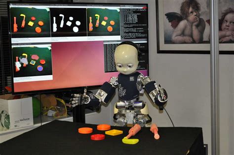 The Icub Robot Looking At A Table Full Of Objects In The Back Screen Download Scientific