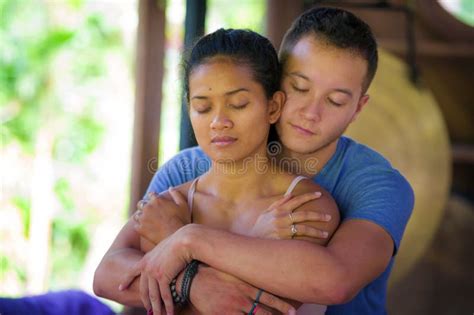 Young Beautiful And Exotic Asian Balinese Woman Receiving Body Healing Thai Massage By