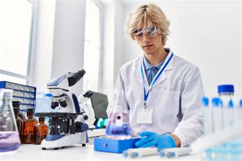 Young Blond Man Scientist Weighing Test Tube At Laboratory Stock Image Image Of Biology