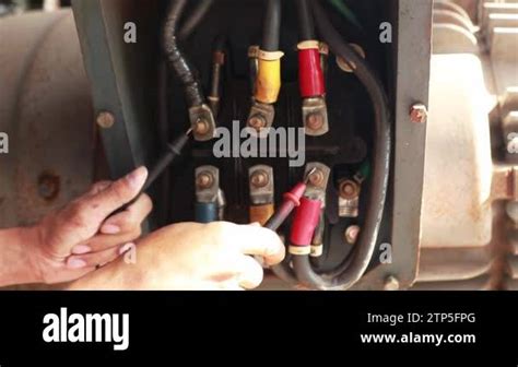 Stop Checking The Motor Repairs Closeup Male Electrician Worker Uses Multimeter To Check Motor