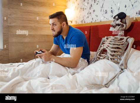 Man Playing Game Console Wife Skeleton In The Bed Bad Relationship Couple Having A Problems