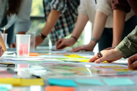 Collaborative Team Brainstorming Session With Colorful Sticky Notes And