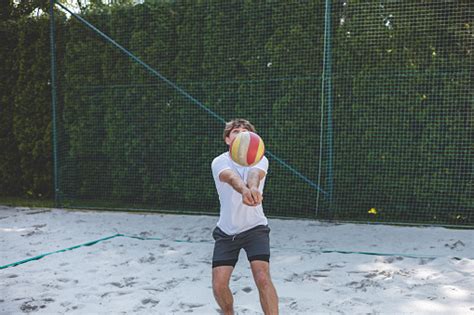 배구 선수가 모래 코트에서 배구 공을 파고 있습니다 야외 환경에서 비치 발리볼의 강렬함과 집중력을 포착하기 25 29세에 대한 스톡 사진 및 기타 이미지 Istock