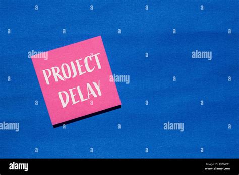 Project Delay Words Written On Pink Paper Sticker With Blue Background Conceptual Project Delay
