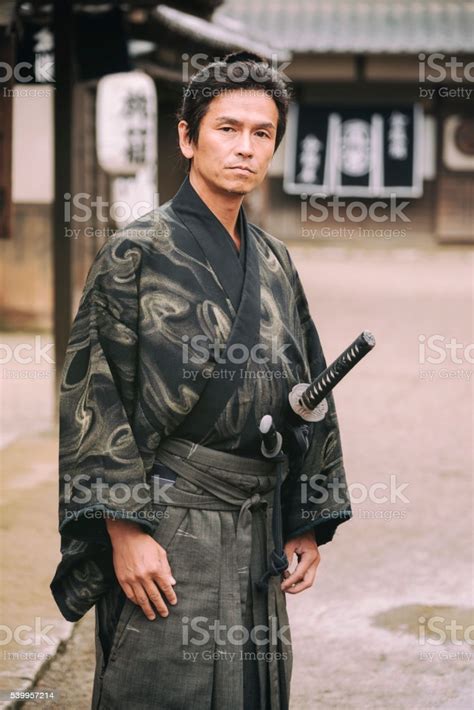 A Japanese Ronin Samurai Stands And Faces The Camera In A Defensive