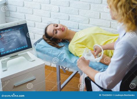 Female Doctor Examines Girls Hand With Ultrasound In Medical Center Stock Image Image Of