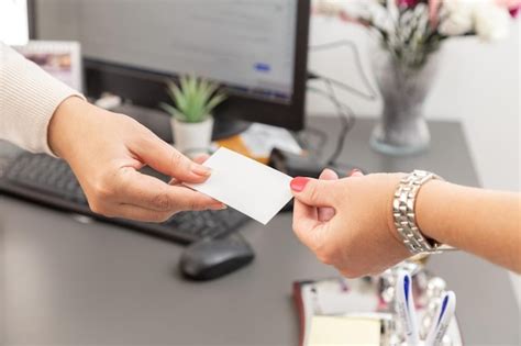 Premium Photo Hands Of Business Women Passing Business Card