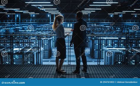 Data Center Male It Specialist And Female E Commerce Manager Talk Use Laptop Big Server Farm
