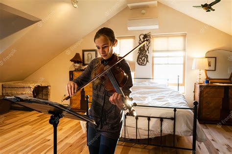 Premium Photo Teenage Girl Playing Her Violin In Her Bedroom
