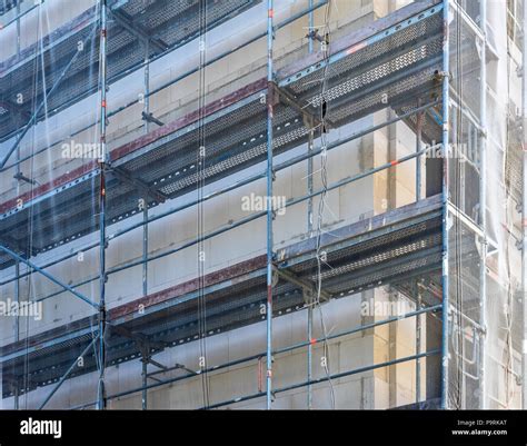 Scaffolding On The Shell Of A Large New Building With A Net To Protect Passers By From Falling