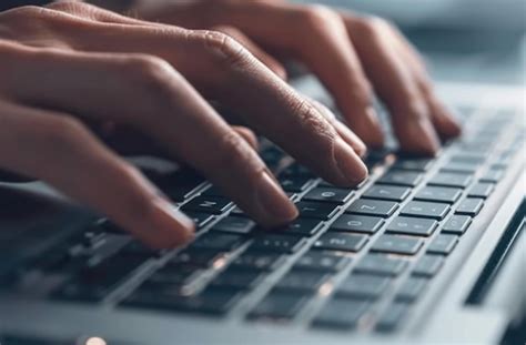 Closeup Lighting Captures The Movement Of Hands Typing On A Laptop