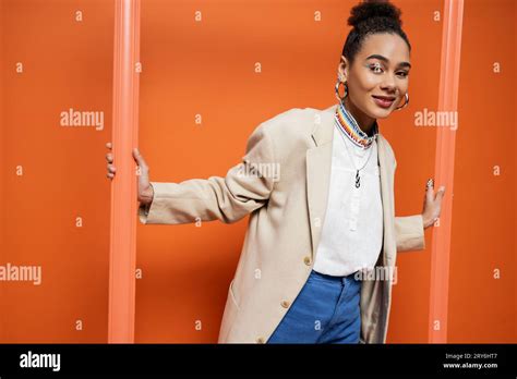Cheerful Beautiful Model In Stylish Beige Blazer And Blue Pants Looking Cheerful Beautiful Model In Stylish Beige Blazer And Blue Pants Looking