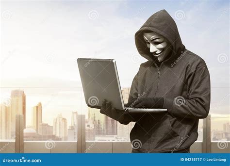 Hacker Man With Anonymous Mask Using Laptop To Hacking Editorial